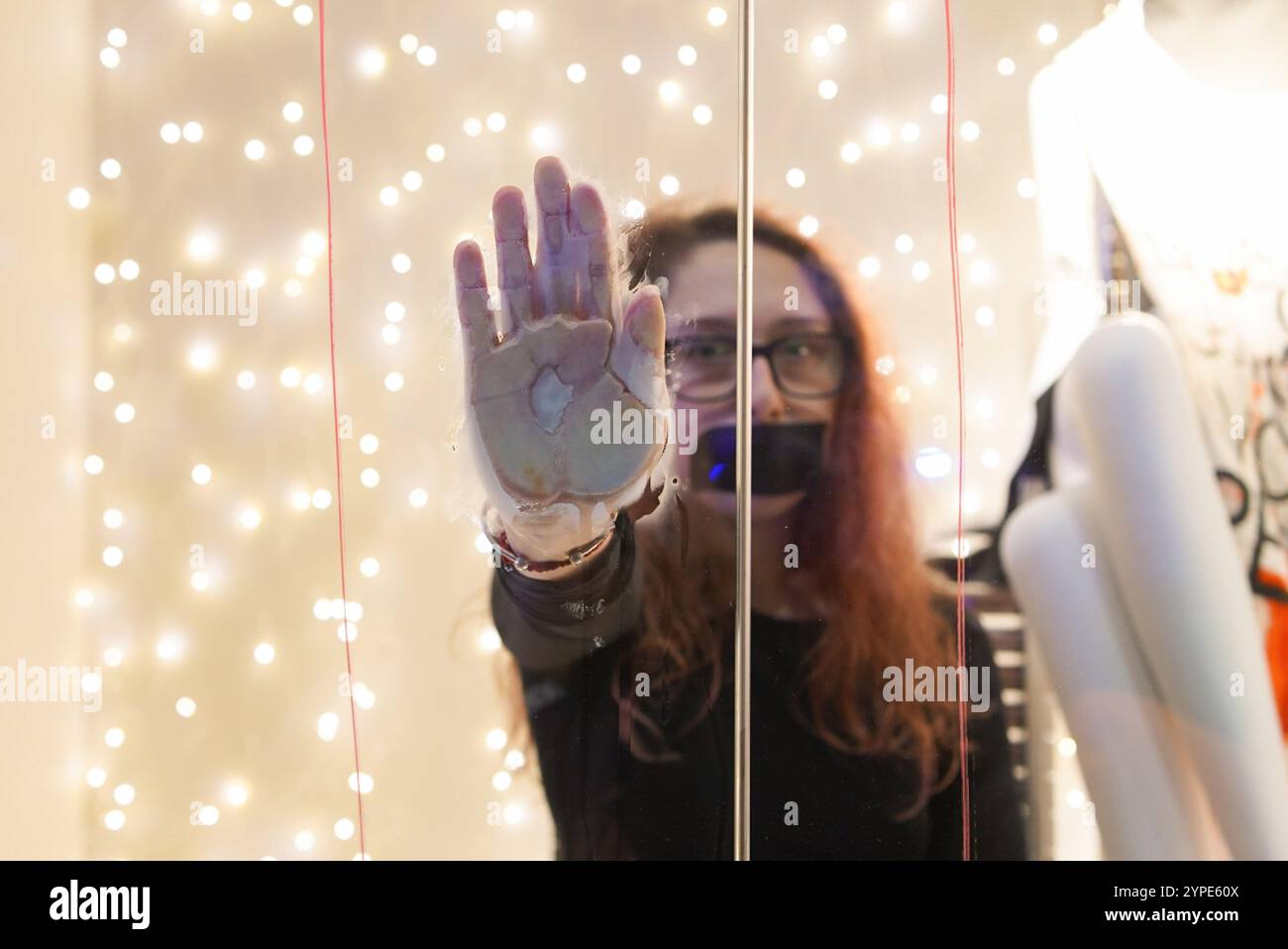 A protester's hand is seen glued to the window during a demonstration ...