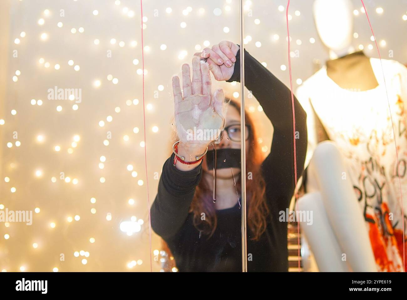 A protester's hand is seen glued to the window during a demonstration ...
