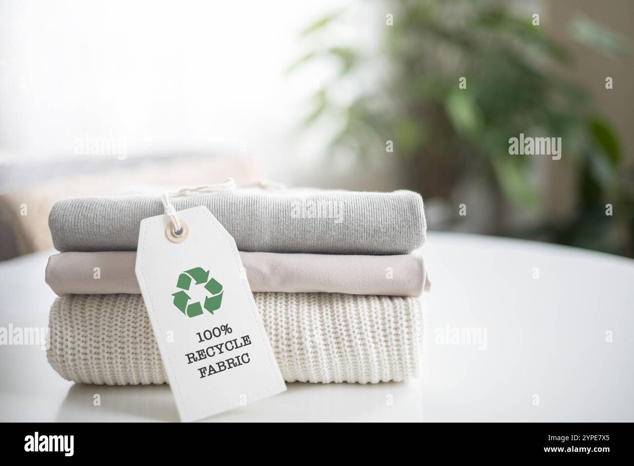 A neat stack of knitted clothing with a 100 percent recycle fabric ...