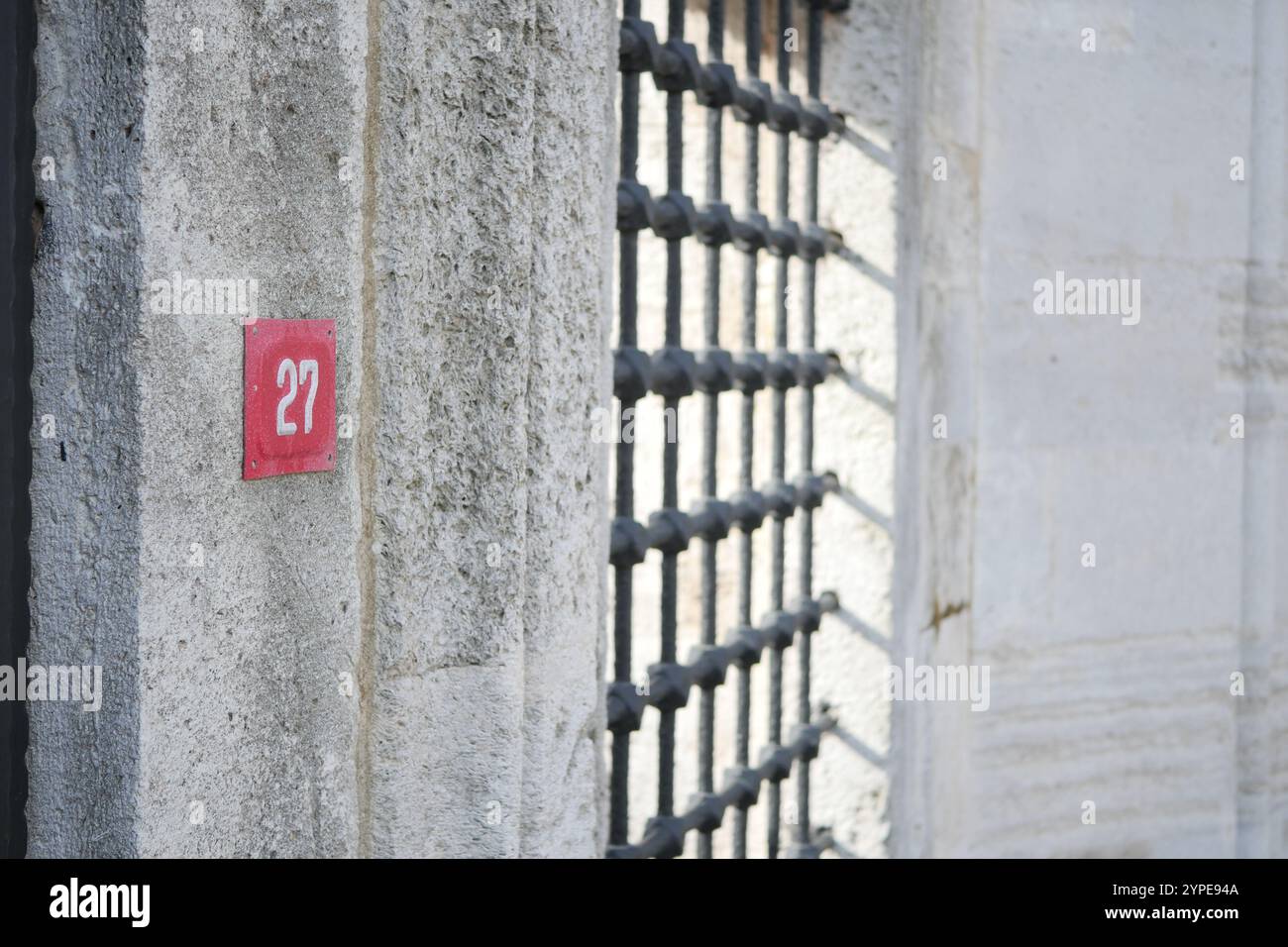A Numbered Jail Cell Door Featuring Sturdy Metal Bars and a Concrete ...
