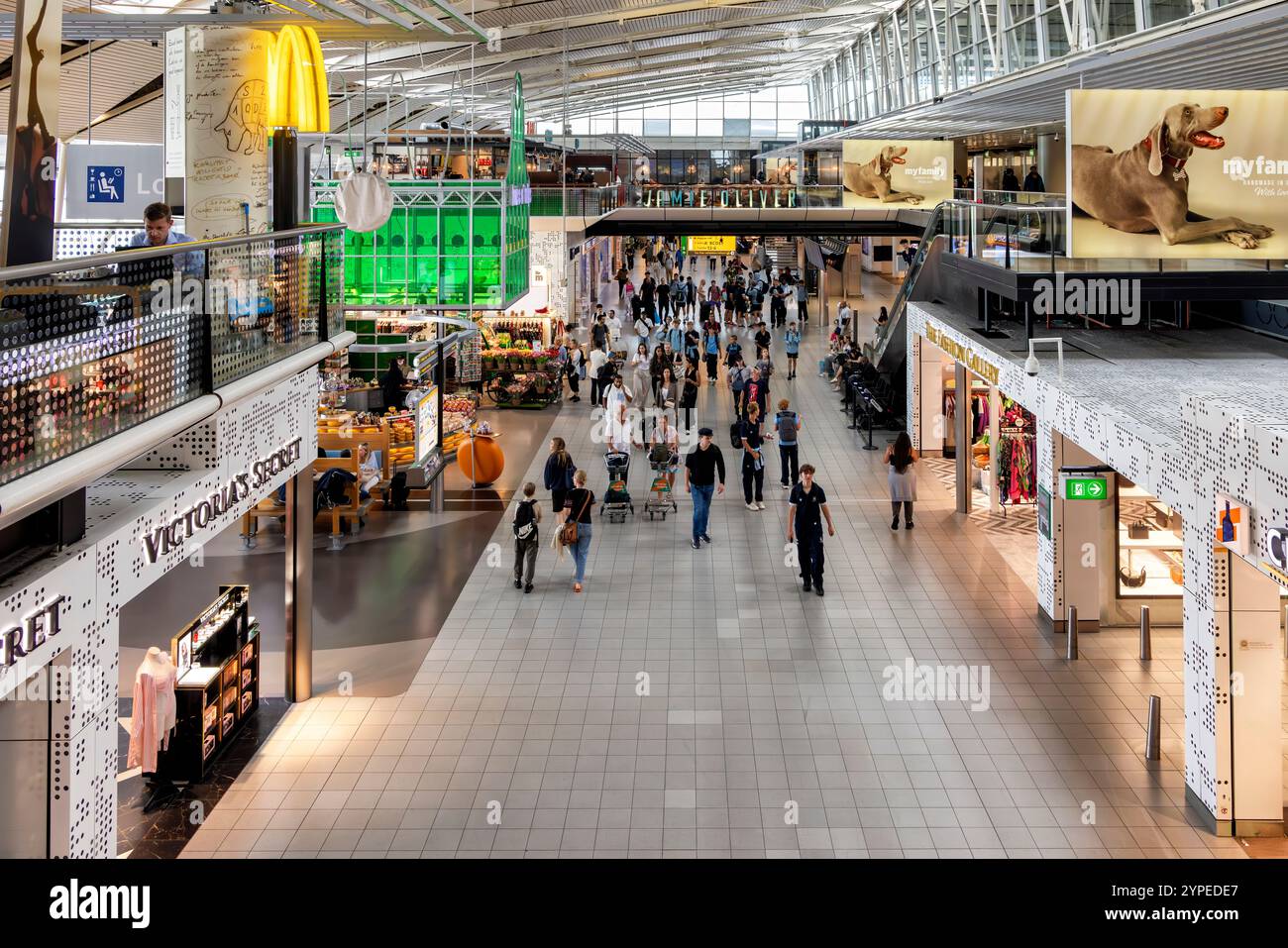 Passengers in terminal building at Schipol International Airport ...