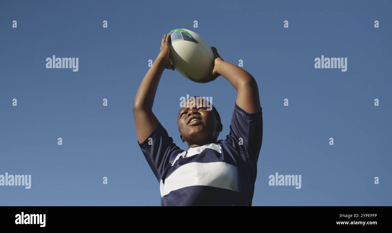 Front view low angle of a young adult biracial female rugby player ...