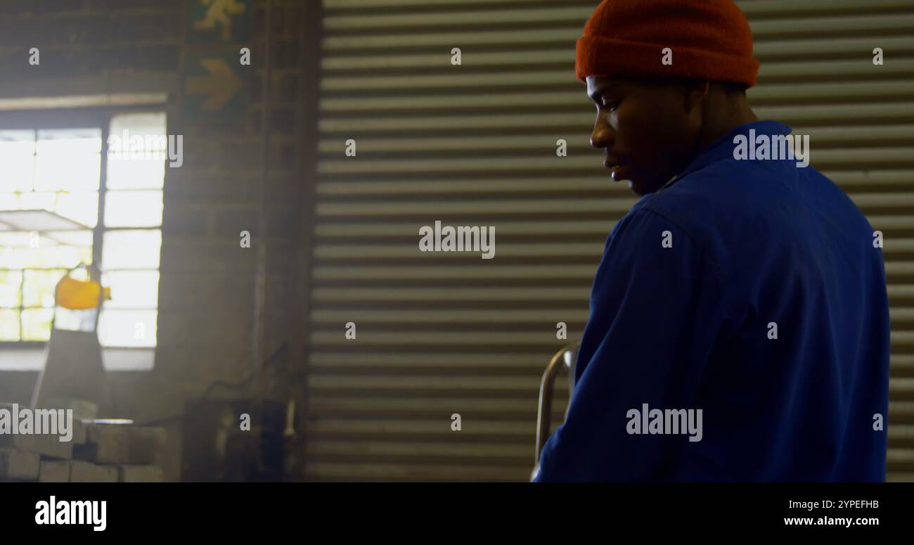 Male worker heating molds in workshop Stock Photo - Alamy