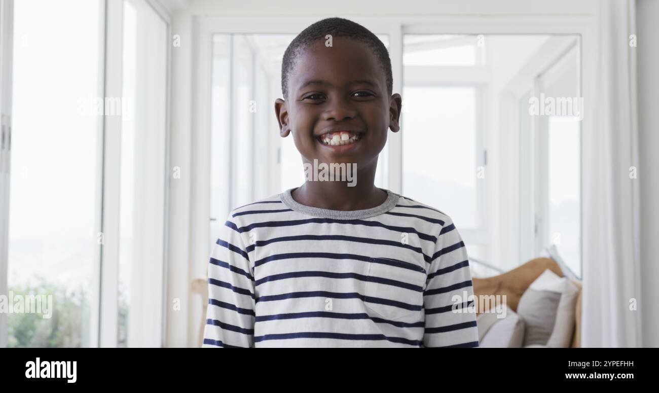 Portrait of a young African American boy at home in the sitting room ...