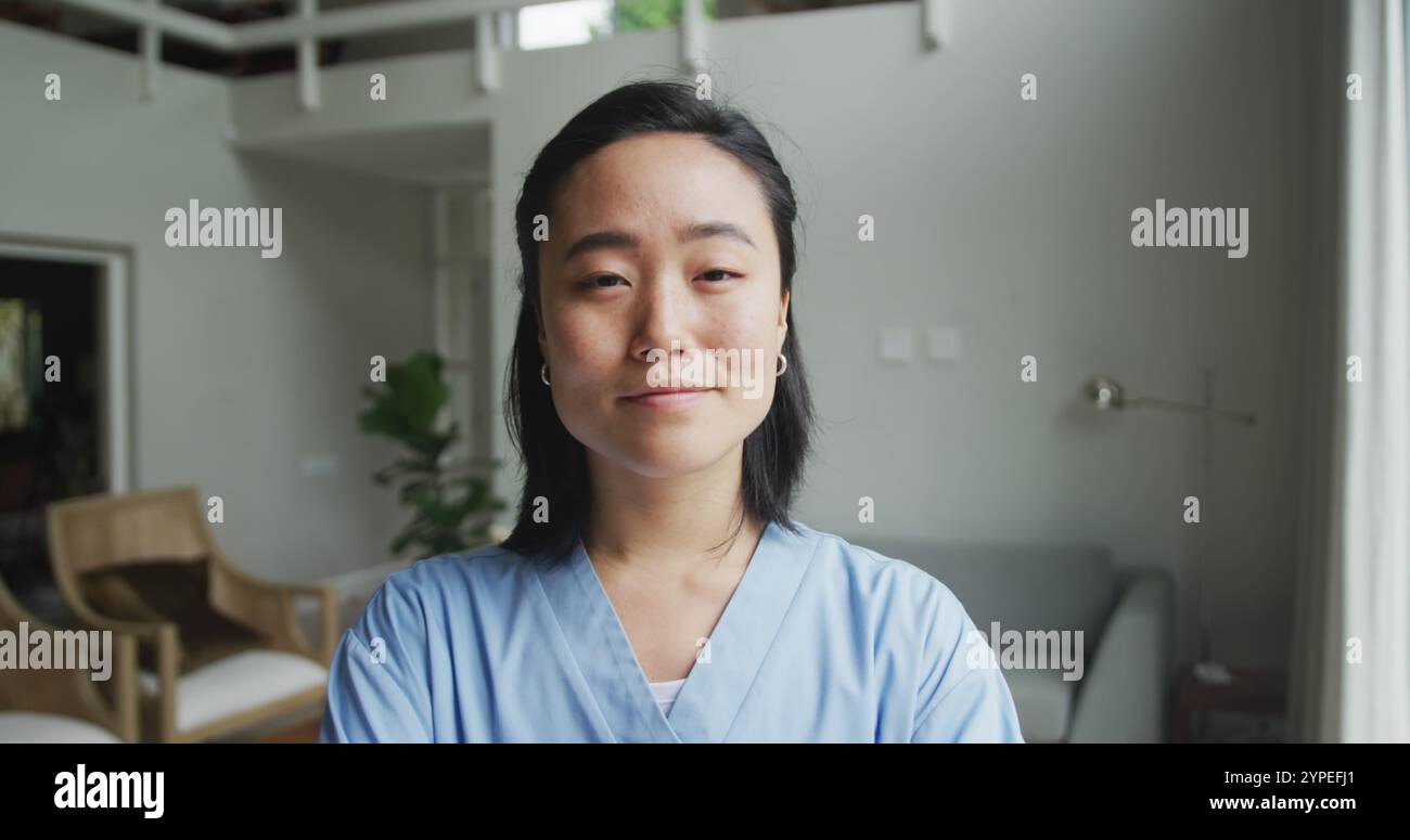 Portrait of happy asian female nurse at work in hospital, smiling to ...