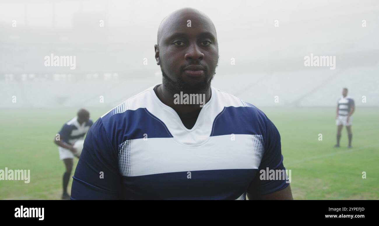 Front view of African american male rugby player standing in stadium ...