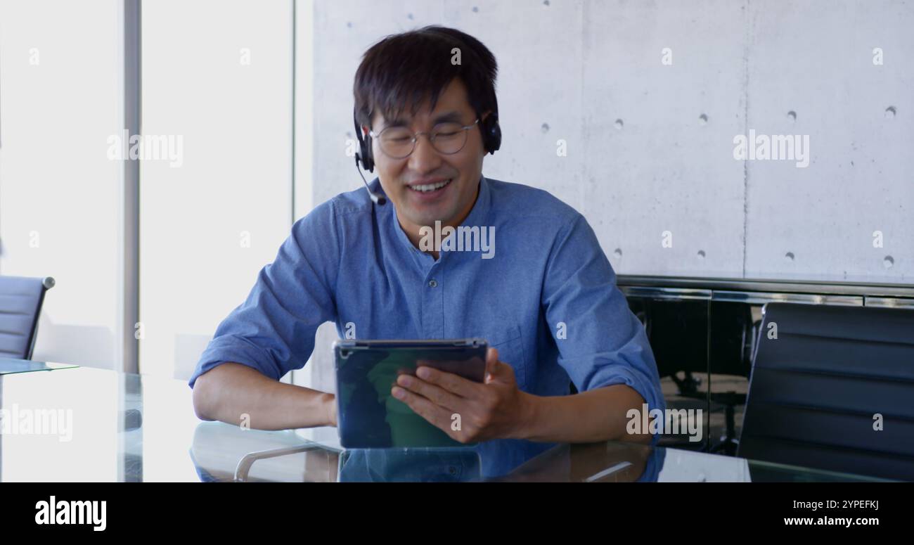 Front view of Asian male executive interacting in the office Stock ...