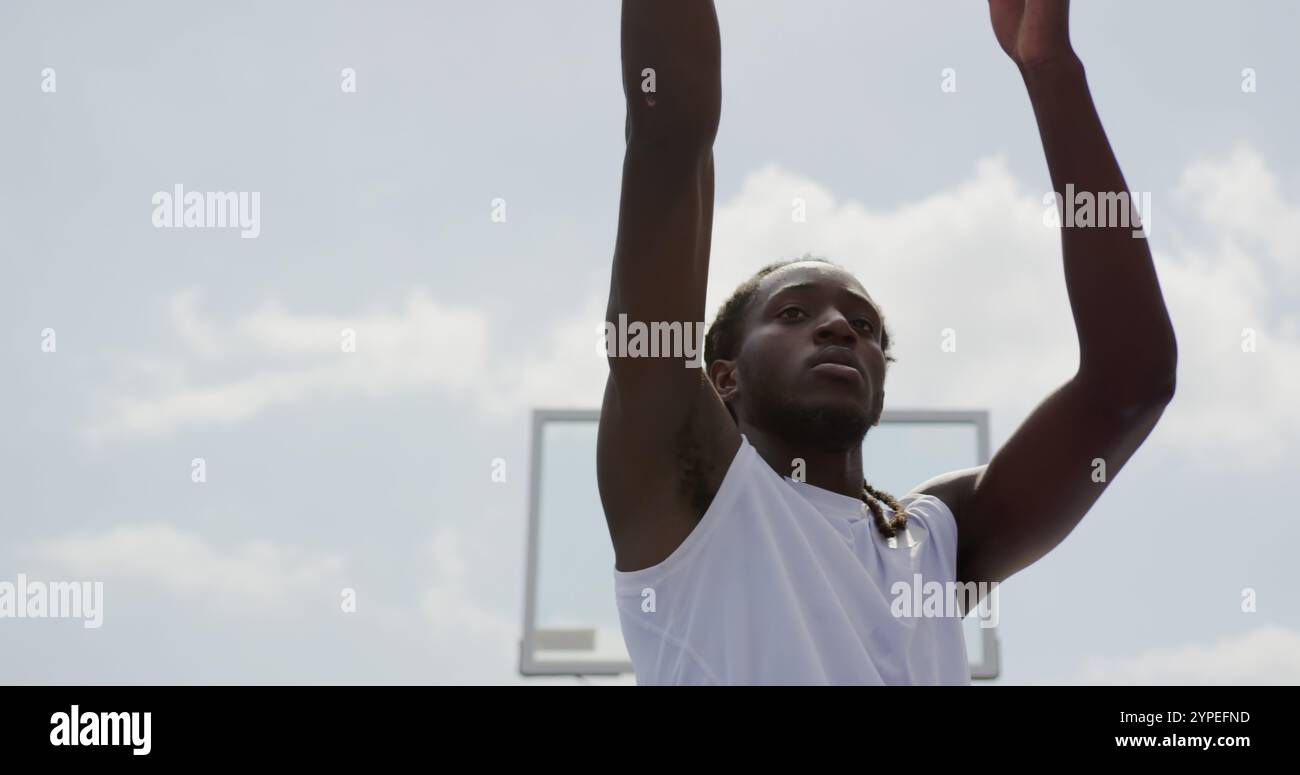 Low angle view of African american basketball player playing basketball ...