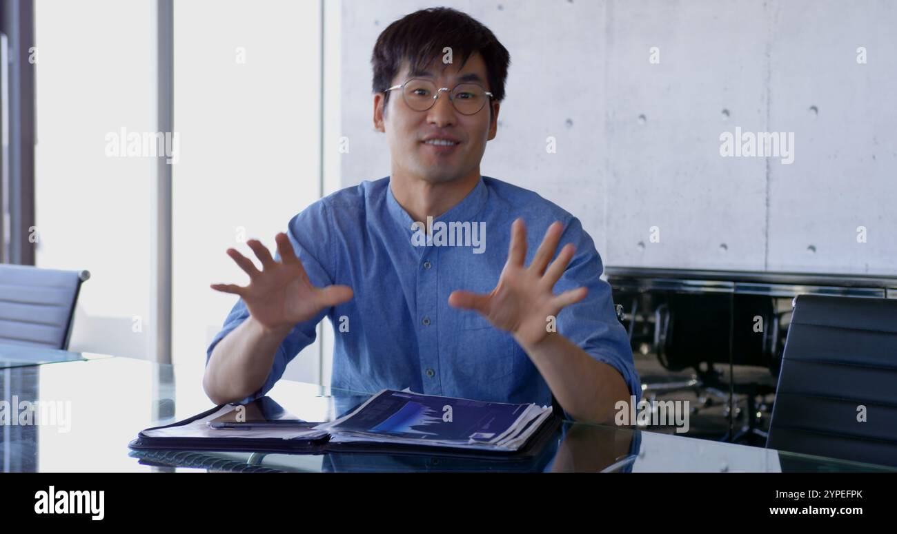 Front view of Asian male executive interacting in the office Stock ...