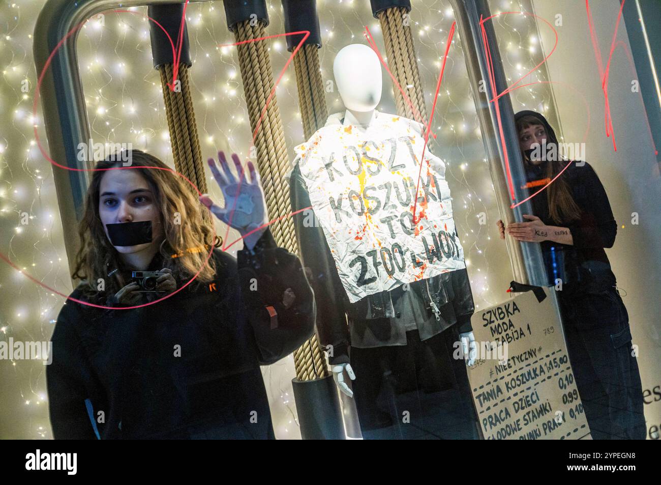 Protestors are seen glued to the display of the high street store next ...