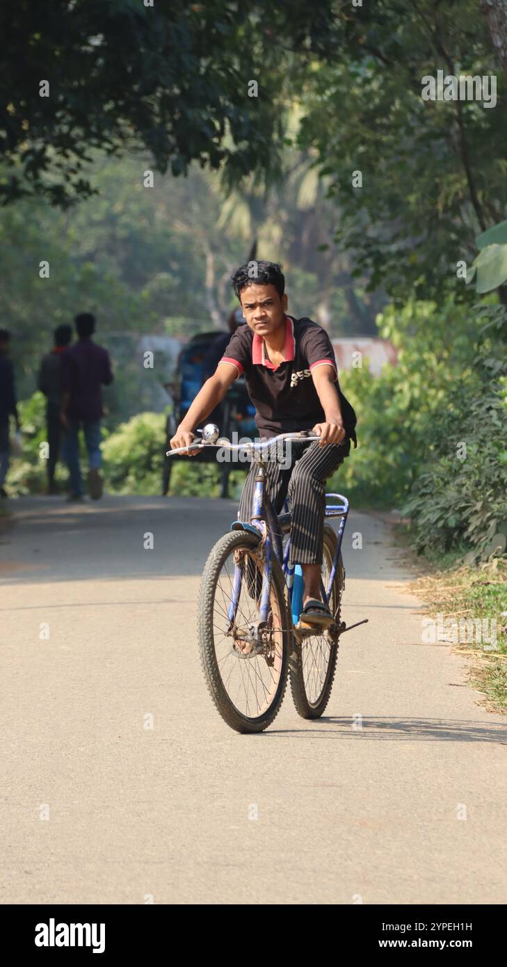 Young Boy Cycling on Rural Pathway Amidst Scenic Greenery Stock Photo ...