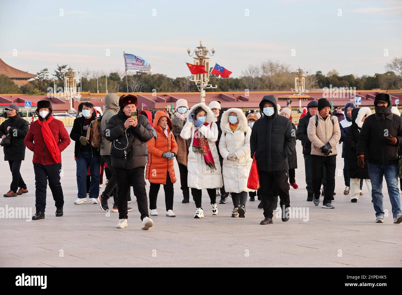 Tourists wear thick clothes to visit the Tiananmen Square in Beijing ...