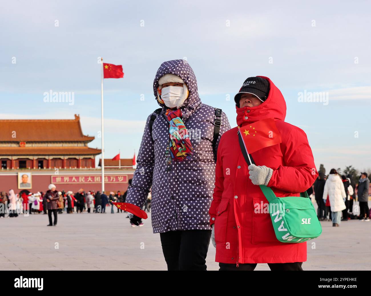 Tourists wear thick clothes to visit the Tiananmen Square in Beijing ...