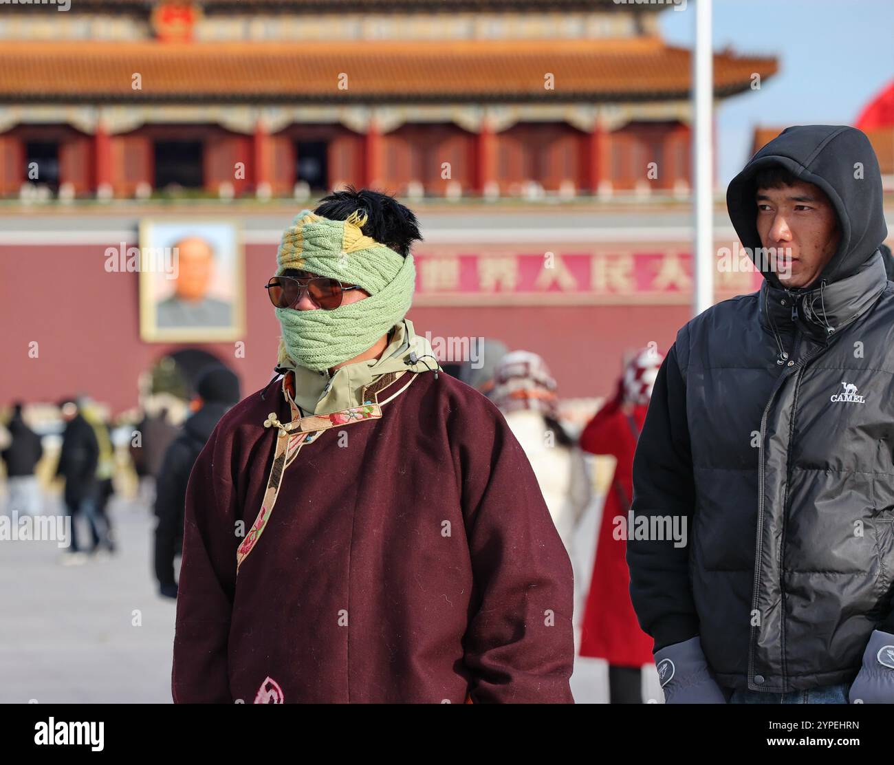 Tourists wear thick clothes to visit the Tiananmen Square in Beijing ...