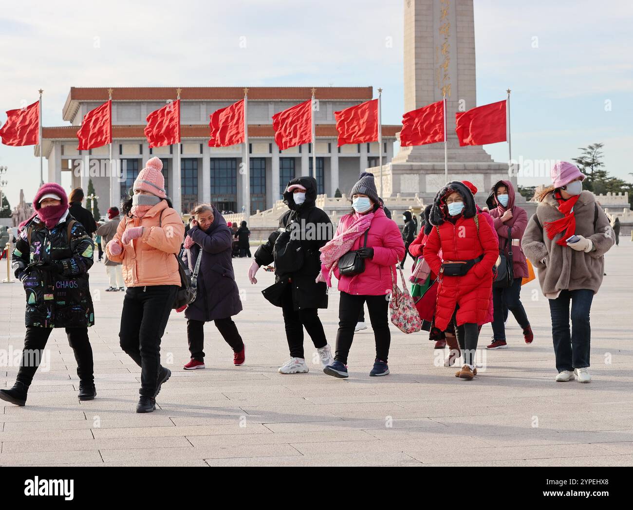 Tourists wear thick clothes to visit the Tiananmen Square in Beijing ...