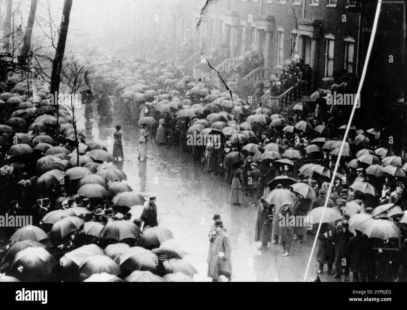 Mourners line the streets during a funeral procession for victims of ...