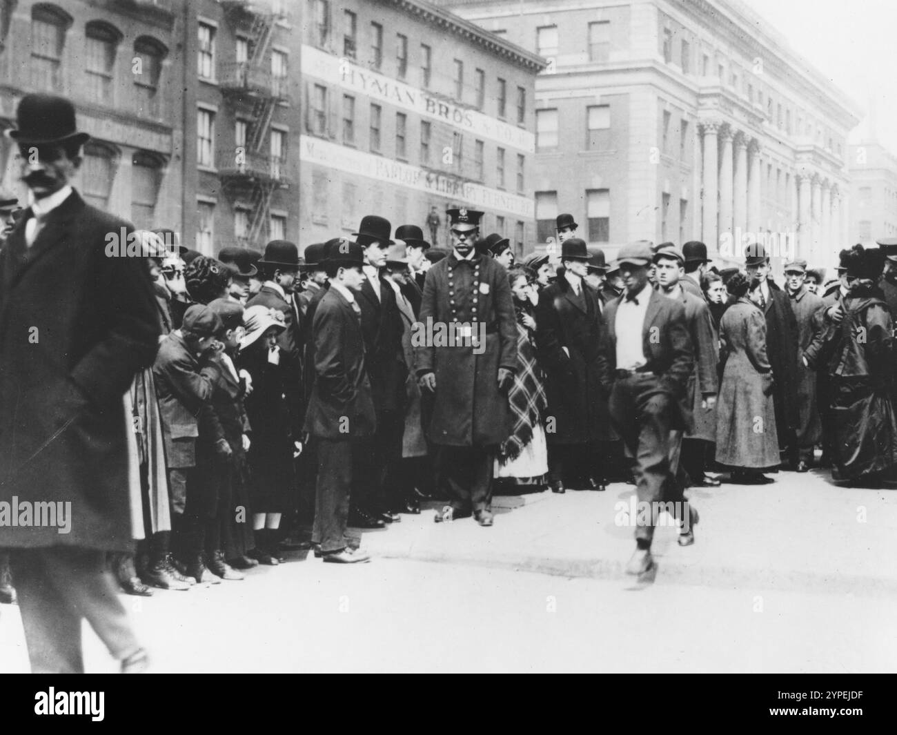 Police officers maintain order among mourners lined up outside the 26th ...