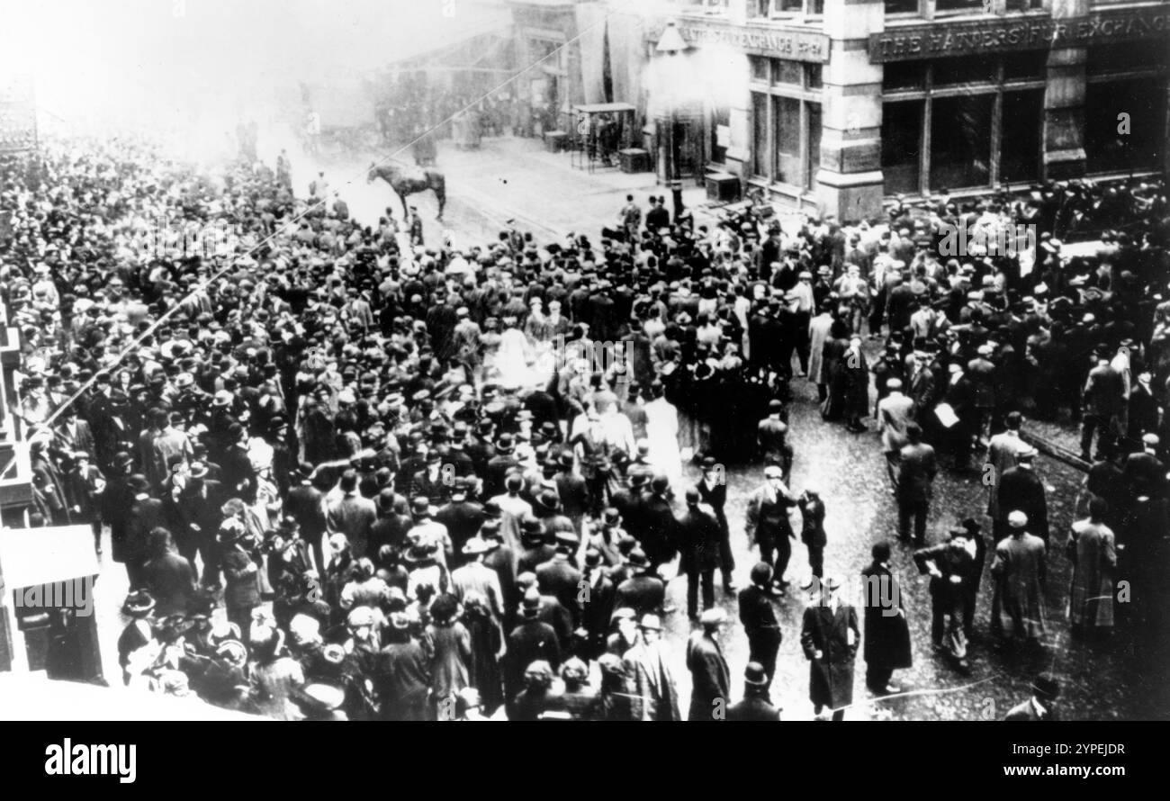 Crowds fill the street and watch as the Asch Building, location of the ...