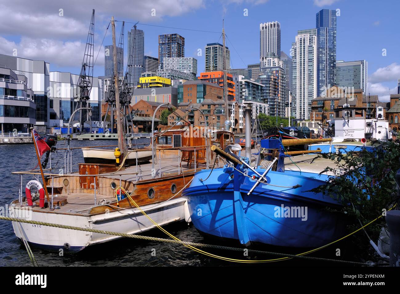 Old barges now houseboats on Millwall Outer Dock and high rise ...