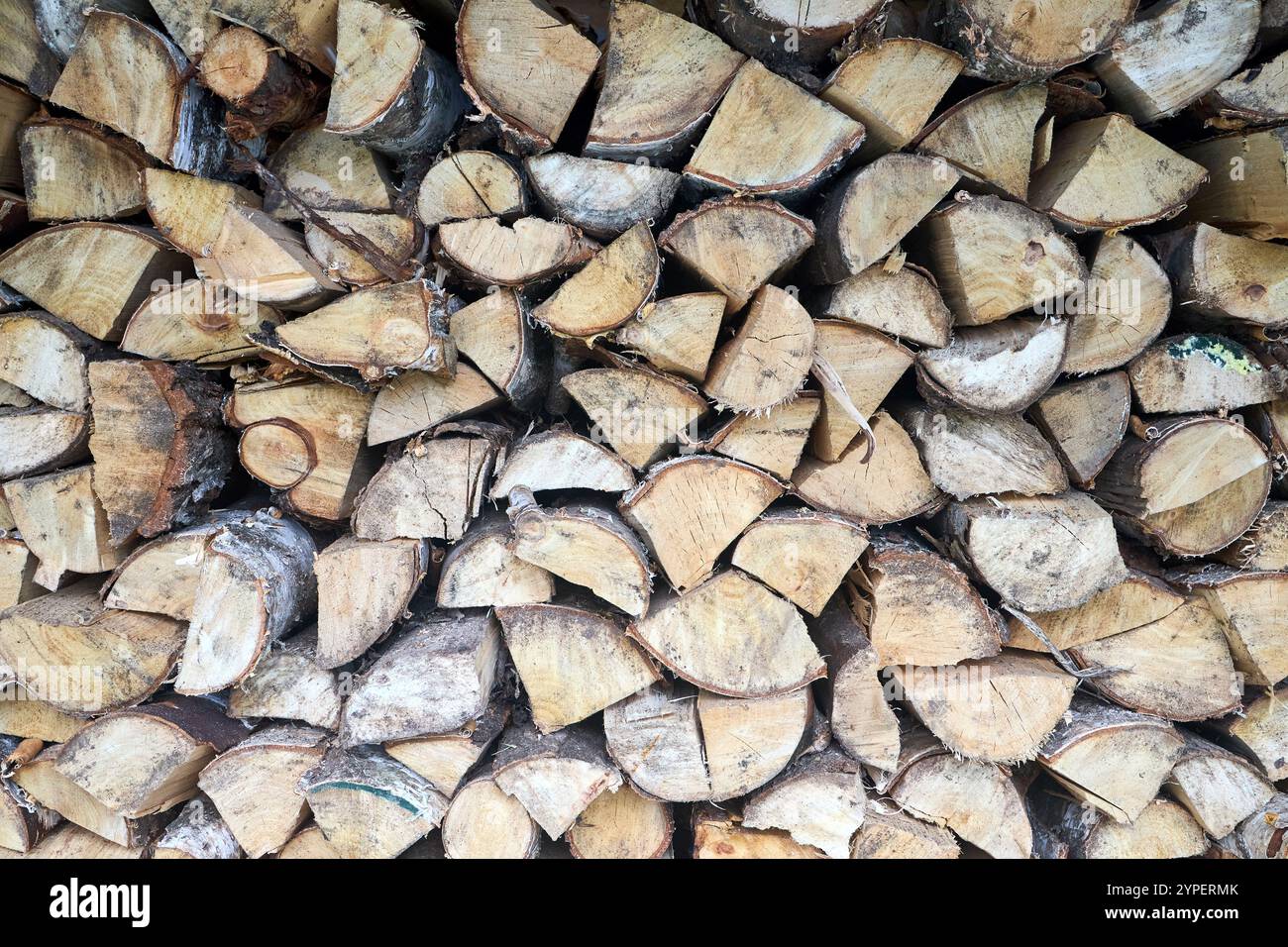Stack of birch firewood with hand chopping block. Chopped firewood for ...