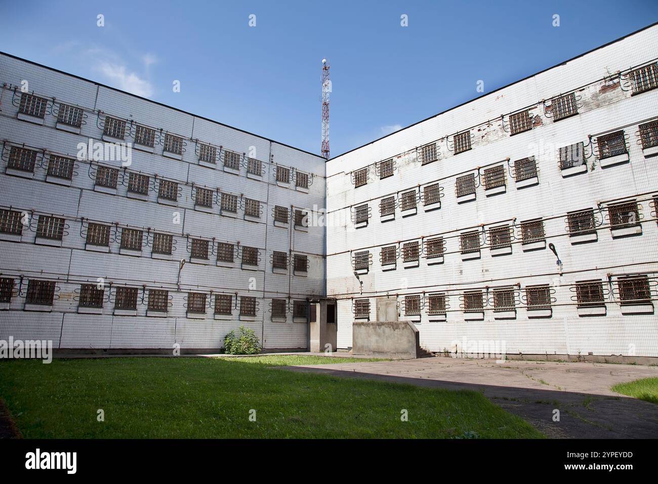 Inner court of abandoned prison jail and windows with heavy iron bars ...