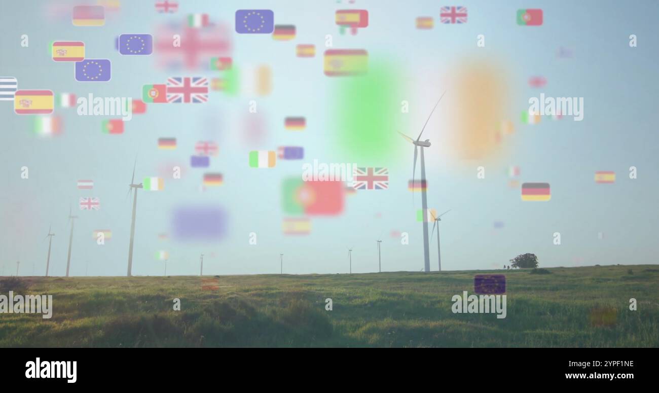 Wind turbines on grassy field with floating international flags image ...