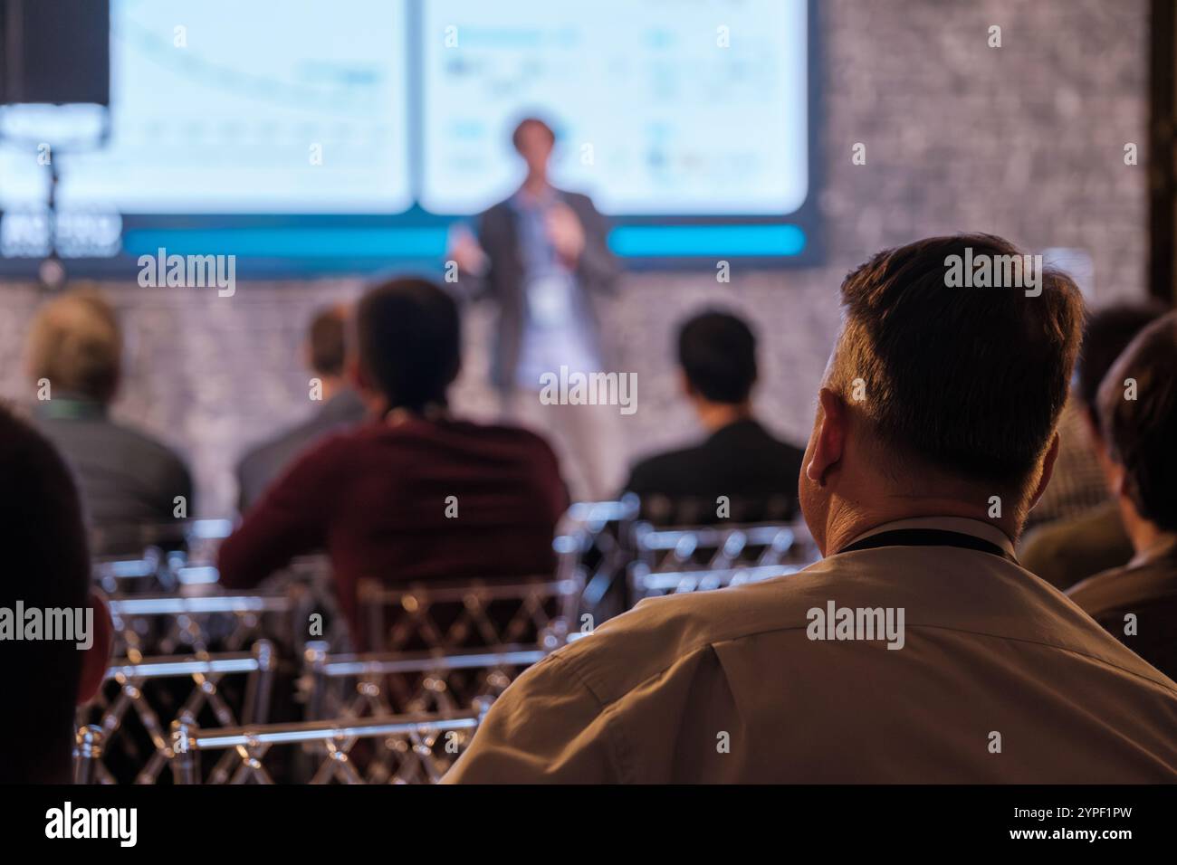 Participants focus on presenter during professional conference with ...