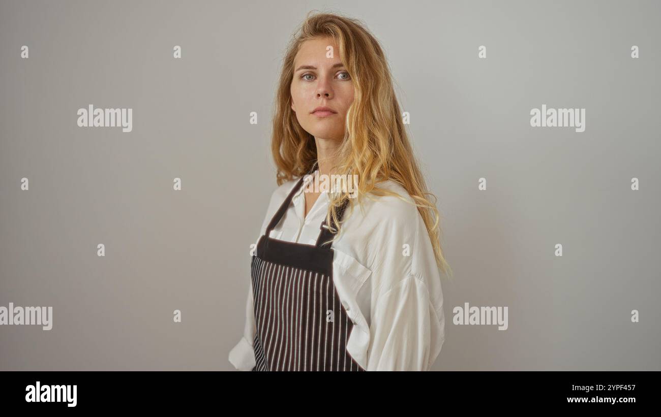 Attractive blonde woman wearing an apron over a white background Stock ...