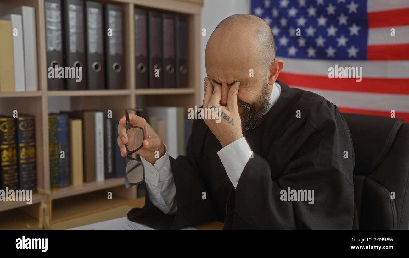 Judge in an american courtroom, a bald hispanic man with a beard, holds ...