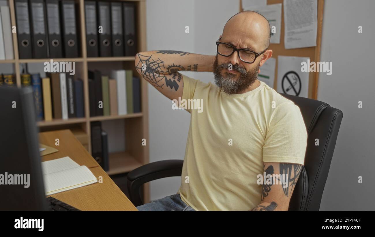 Hispanic man in an indoor office setting with tattoos and a beard ...