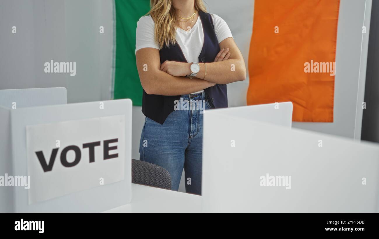 A young woman stands in an electoral college room with her arms crossed ...