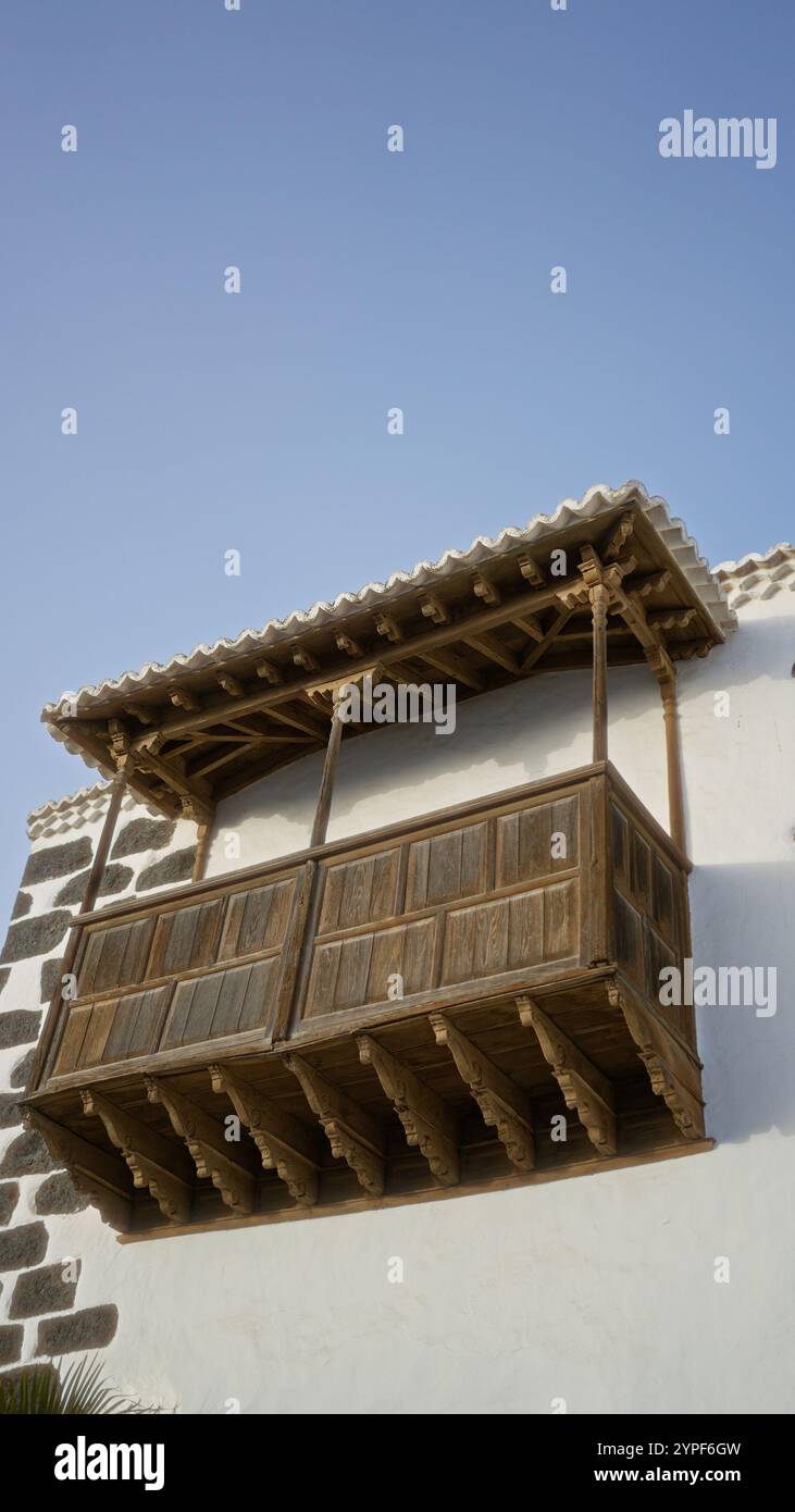 Traditional wooden balcony on a historic building with white stone ...