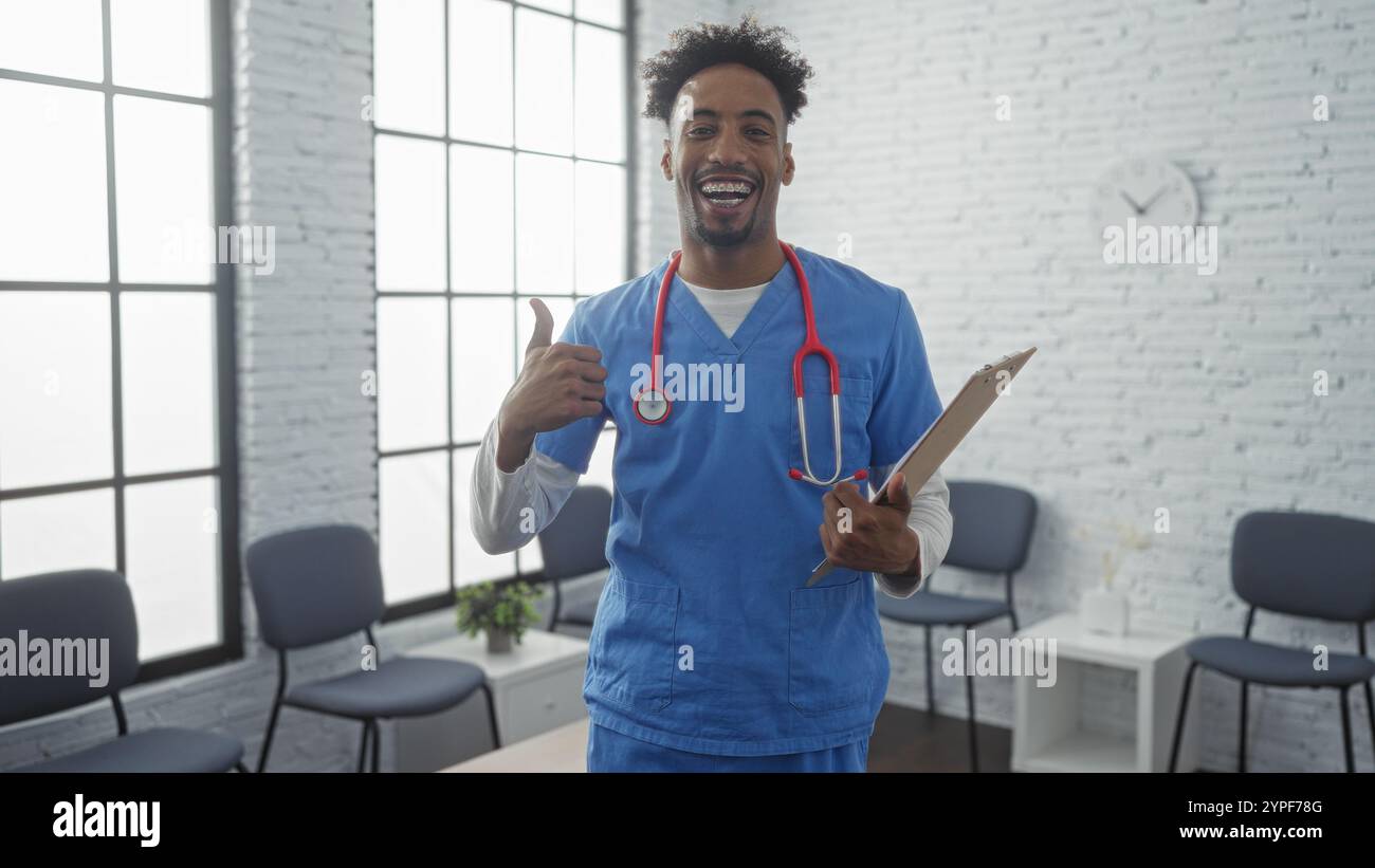 A young african american male nurse with a beard gives a thumbs up in a ...