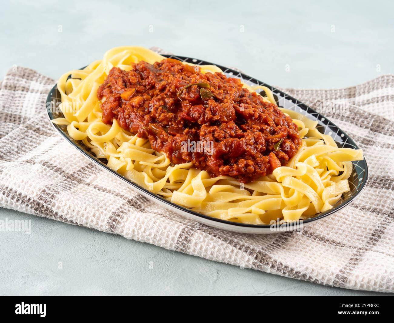Tagliatelle with vegan tomato bolognese ragu with soya protein granules ...