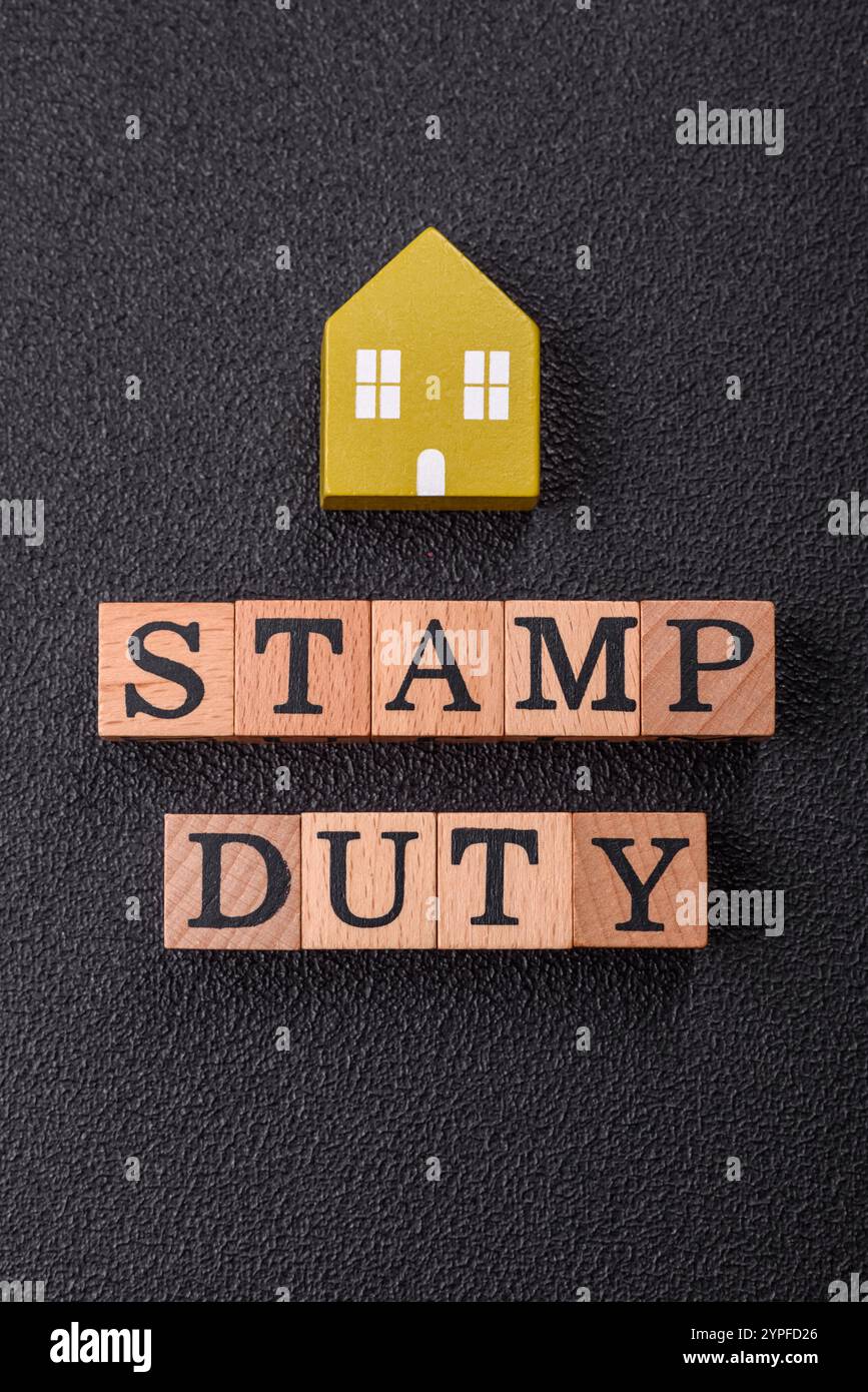 The inscription Stamp Duty made of wooden cubes on a plain background ...
