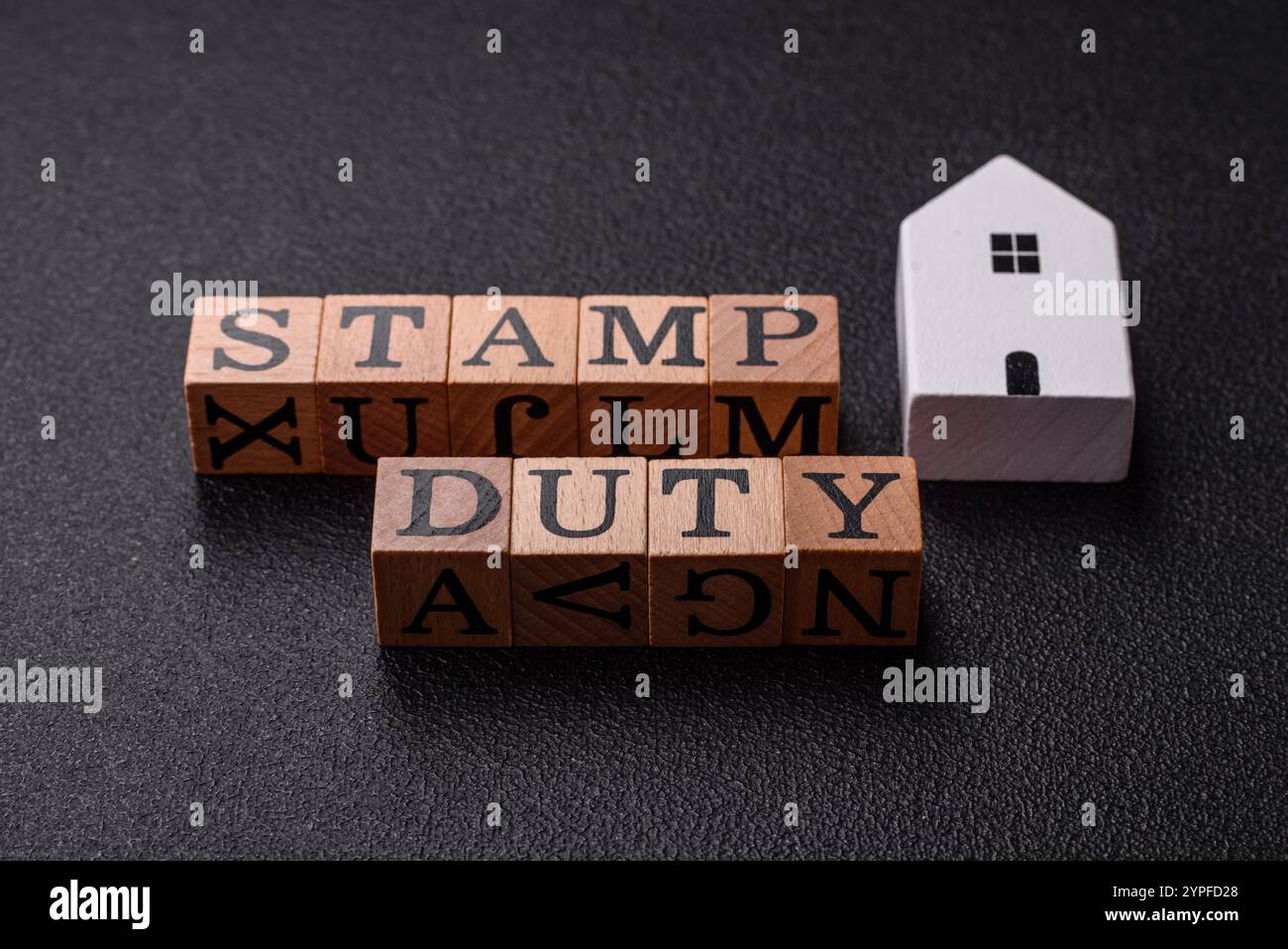 The inscription Stamp Duty made of wooden cubes on a plain background ...