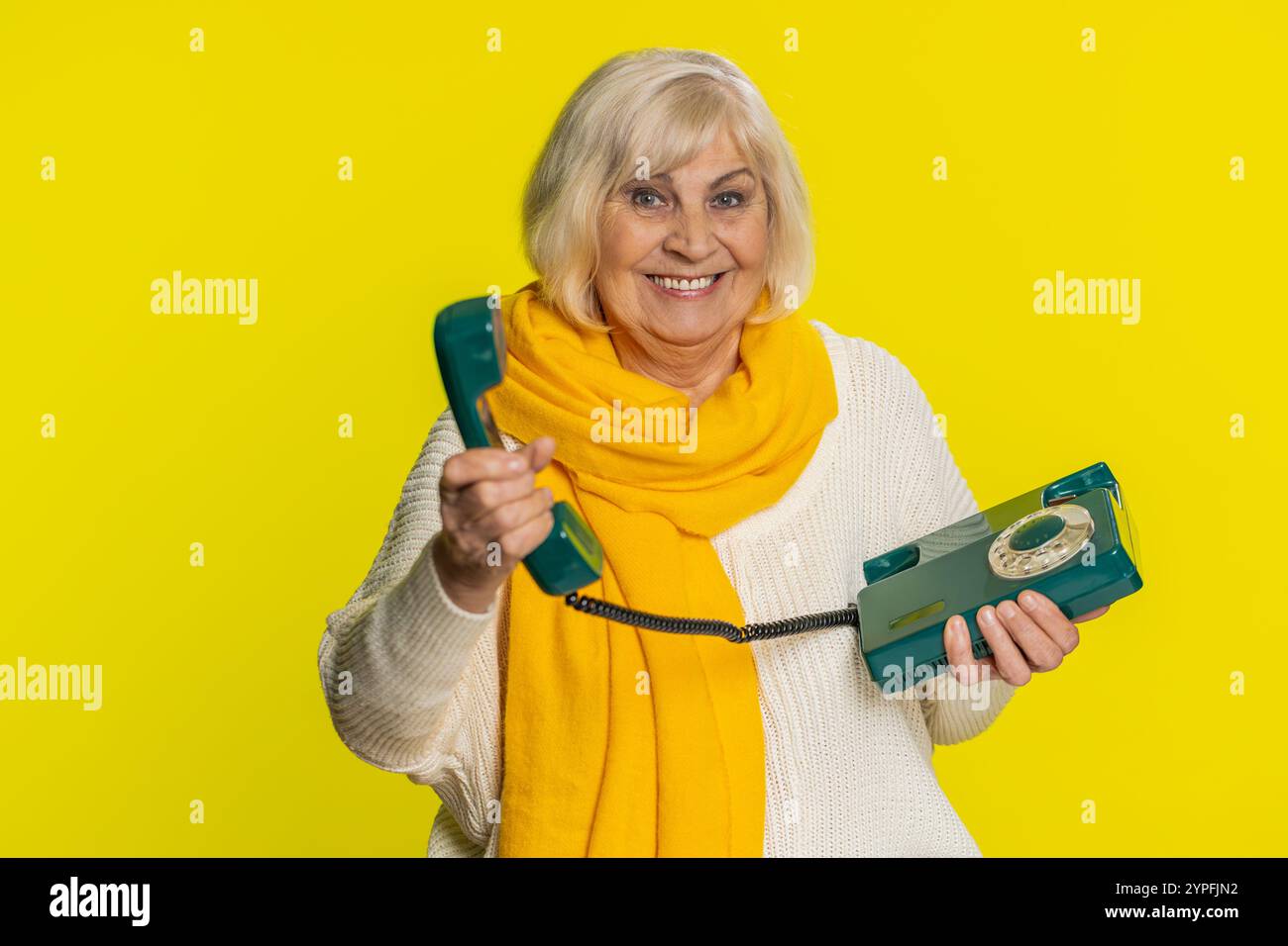 Hey you, call me back. Senior old woman talking on wired landline ...