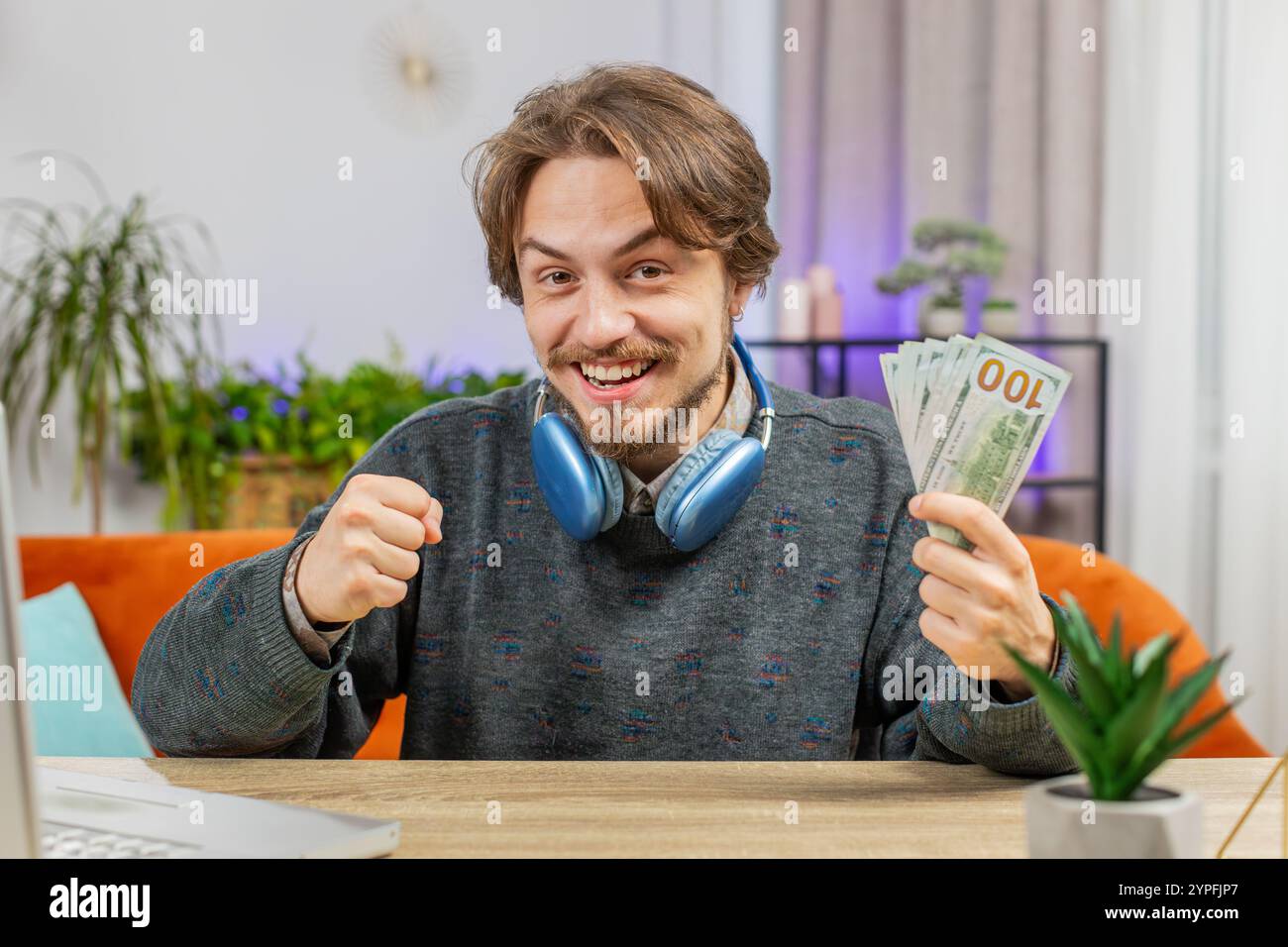 Planning budget. Rich happy business man counting money cash use laptop ...