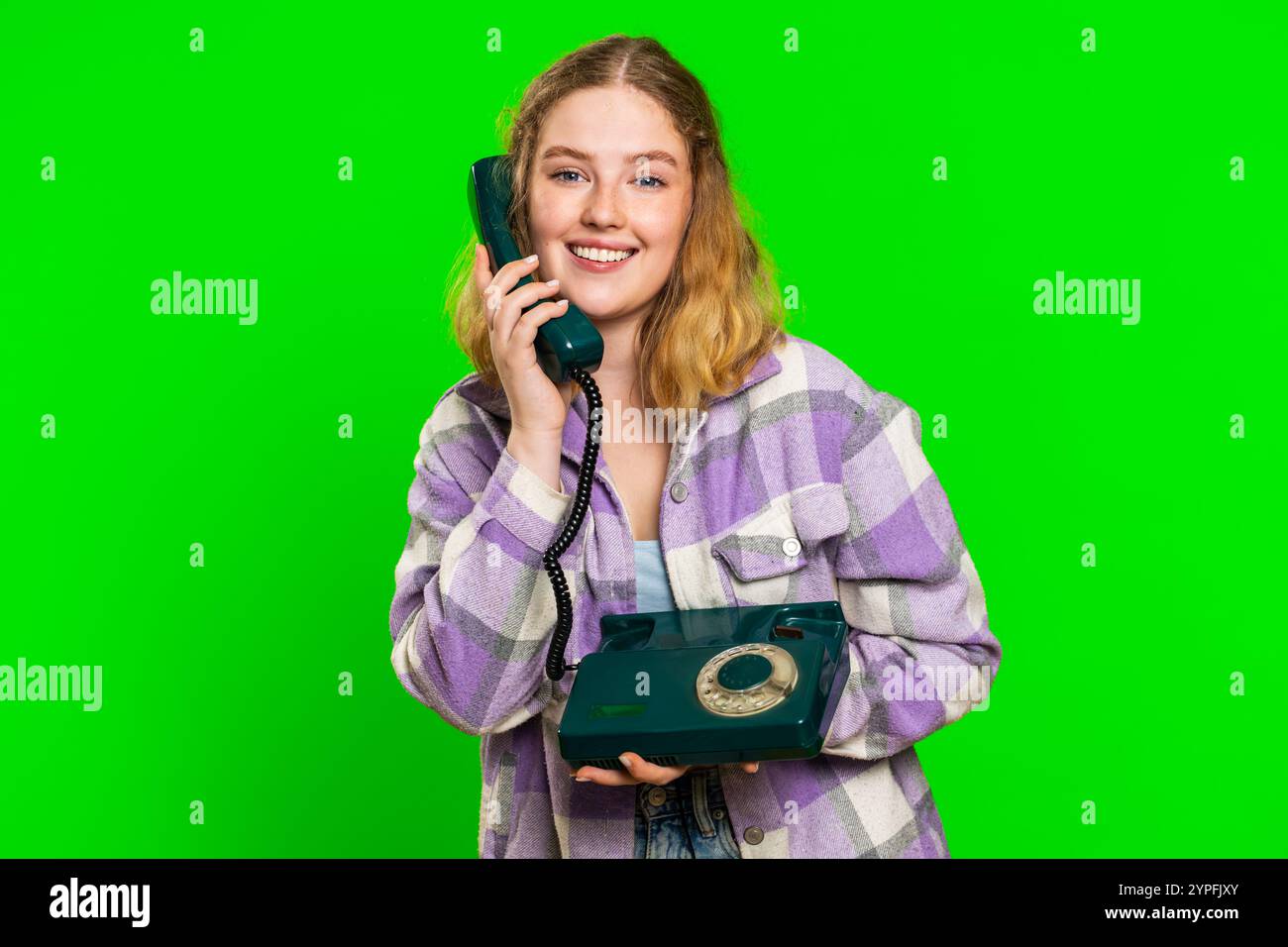 Hey you, call me back. Young woman talking on wired landline vintage ...
