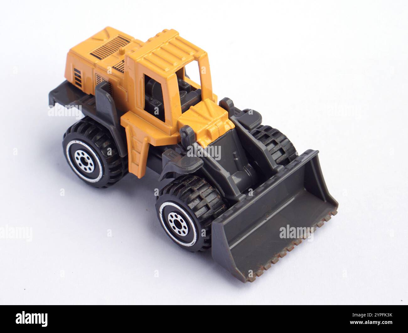 high angle view of yellow toy bulldozer isolated on white background ...