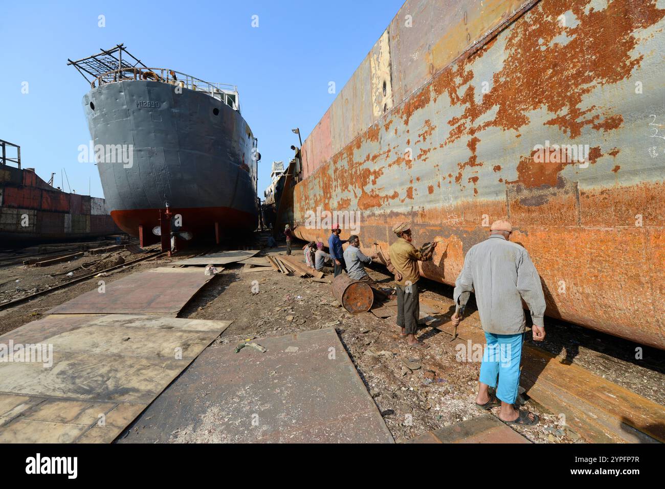 Bangladeshi men working on ships at shipyard by the Buriganga river in ...