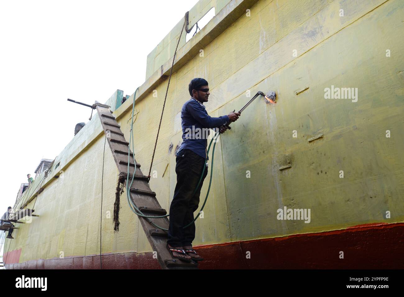 Bangladeshi men working on ships at shipyard by the Buriganga river in ...