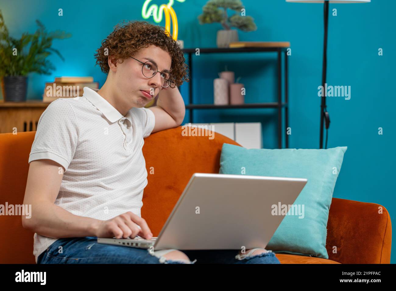 Tired bored young male freelancer brunette man using laptop, problem ...