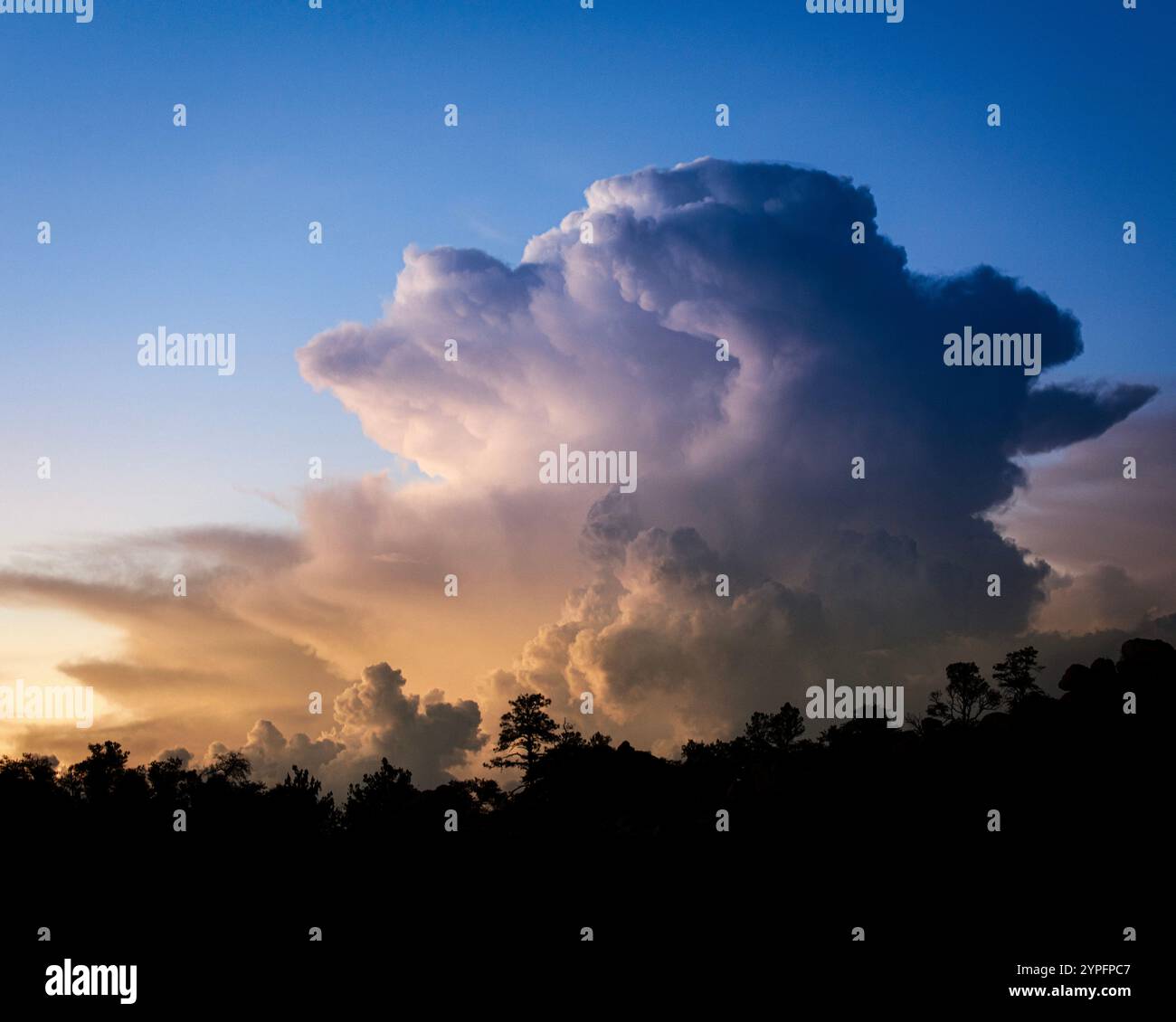 Late afternoon light works through the clouds around Granite Mountain ...