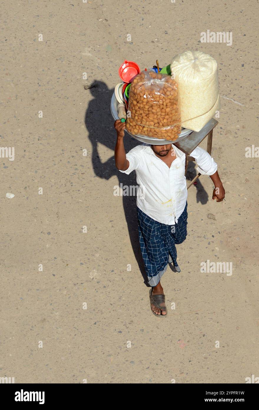 A snack vendor walking by the garment factories in Dhaka, Bangladesh ...