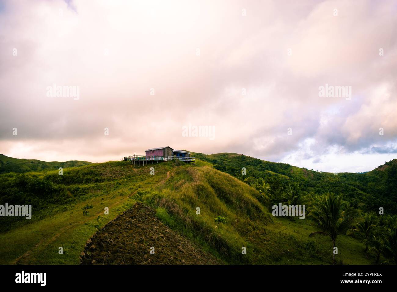 A wooden hut on top of a hill during sunrise. Cabaliwan Peak, Romblon ...