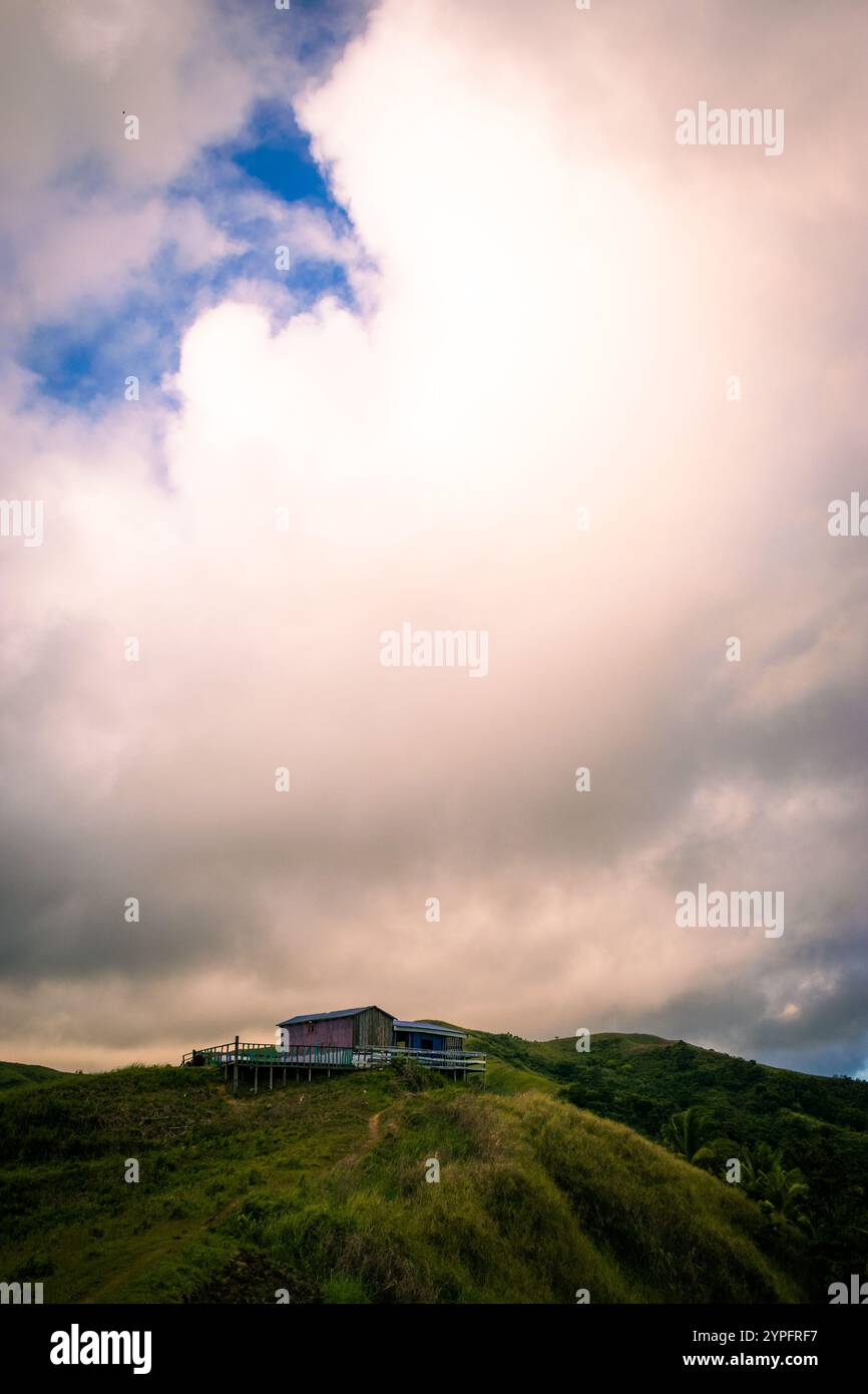 A wooden hut on top of a hill during sunrise. Portrait. Cabaliwan Peak ...