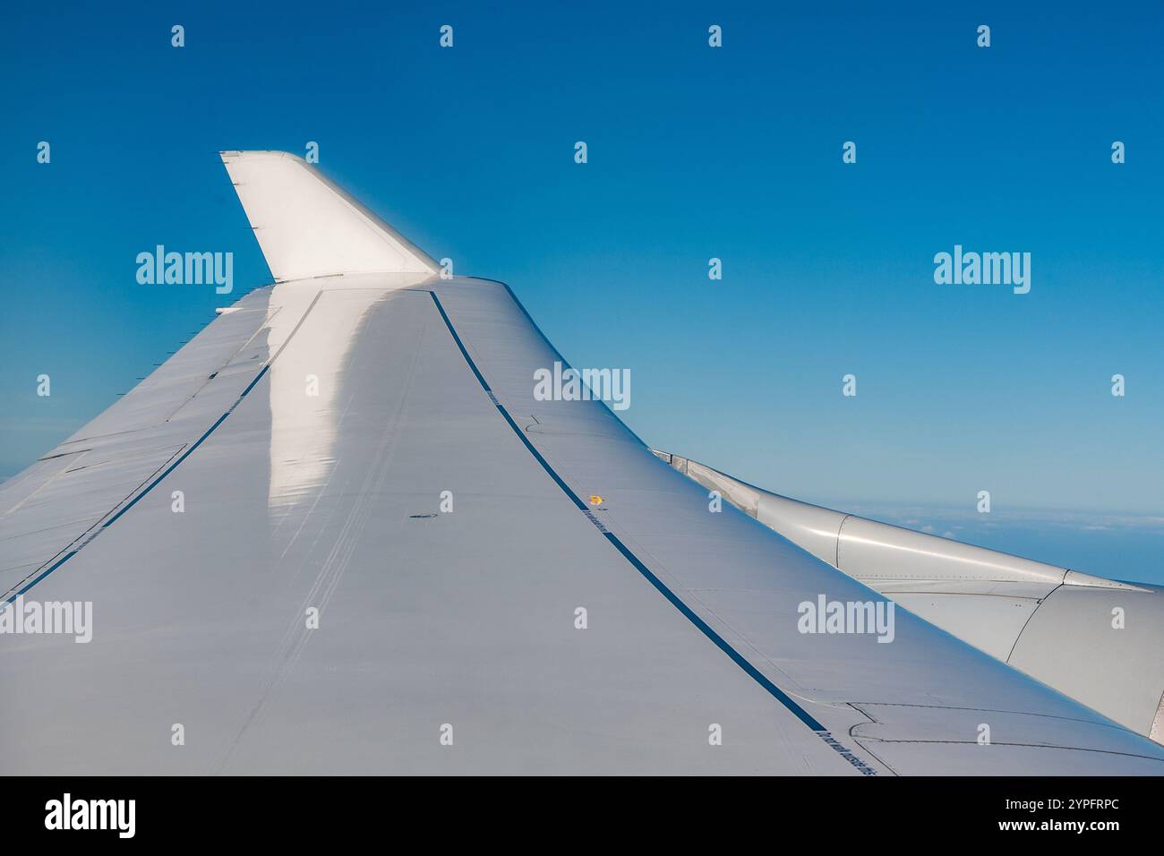 detail of wing of aircraft in blue sky Stock Photo - Alamy