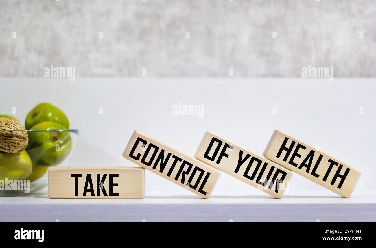 Take control of your health, text with wooden blocks on a white ...