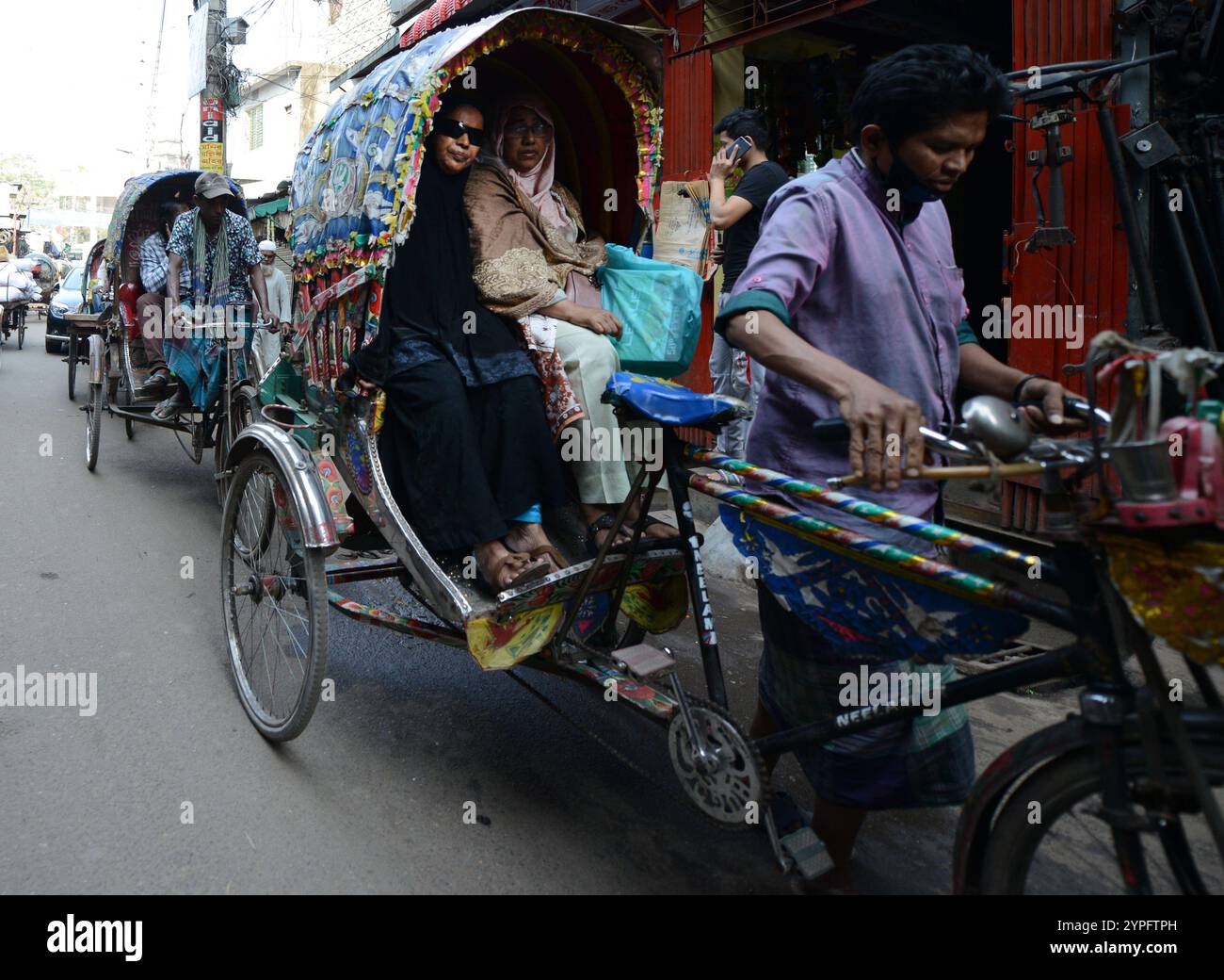 Colorful cycle rickshaws roaming the streets of Dhaka, Bangladesh Stock Photo - Alamy